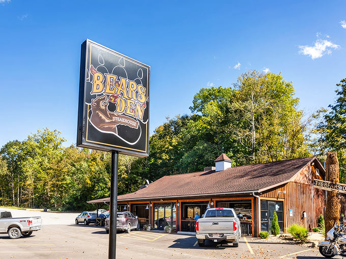 The Bear's Den Steakhouse sign stands tall against the blue Ohio sky, promising carnivorous delights within those rustic wooden walls.