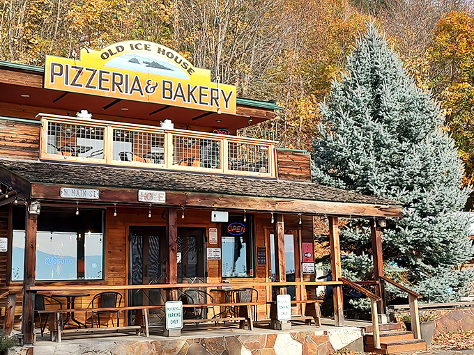 The Old Ice House Pizzeria's rustic wooden facade feels like stepping into a storybook, complete with that inviting deck where pizza dreams come true.
