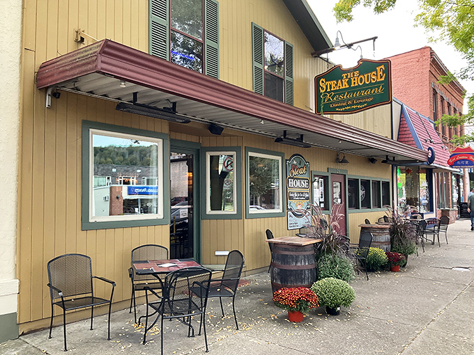 The Steak House's sunny yellow exterior is like a beacon of hope for hungry travelers on Wellsboro's charming Main Street.