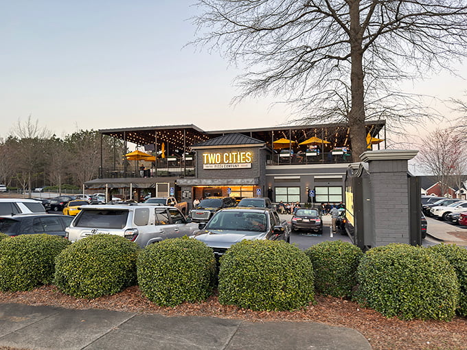 Two Cities Pizza Co. exterior gleams at dusk, with its modern design promising a tale of two pizza traditions under one stylish roof.