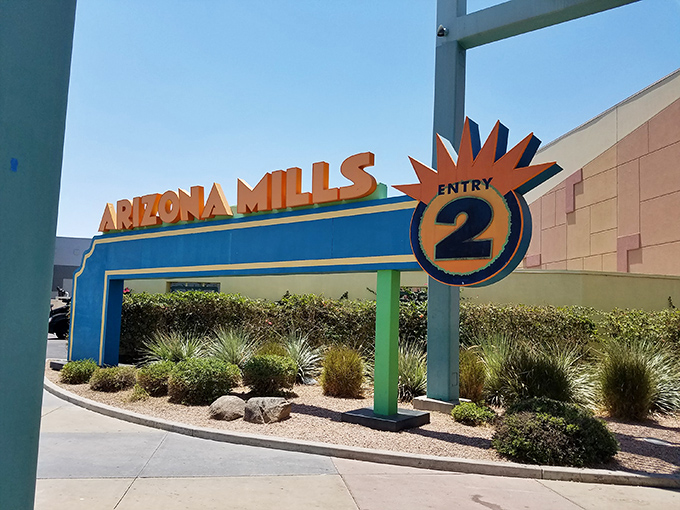 Entry 2 beckons with its retro-futuristic sign, promising a shopping adventure that's part bargain hunt, part desert oasis escape.