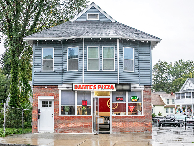 Rain can't keep pizza lovers away from Dante's brick storefront. That glowing "OPEN" sign feels like a warm hug.