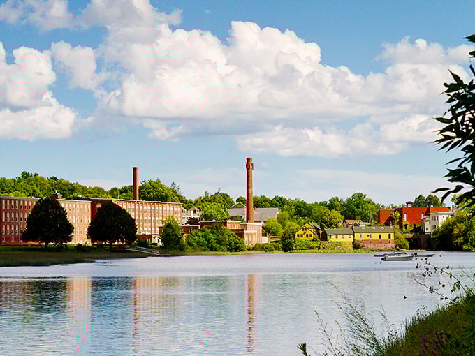Historic mill buildings reflect in the Exeter River, creating a postcard scene that's actually affordable to live near.