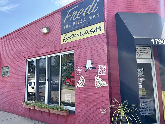 Pizza art on a bright pink canvas! Fredi's colorful storefront promises a slice of Michigan magic inside.
