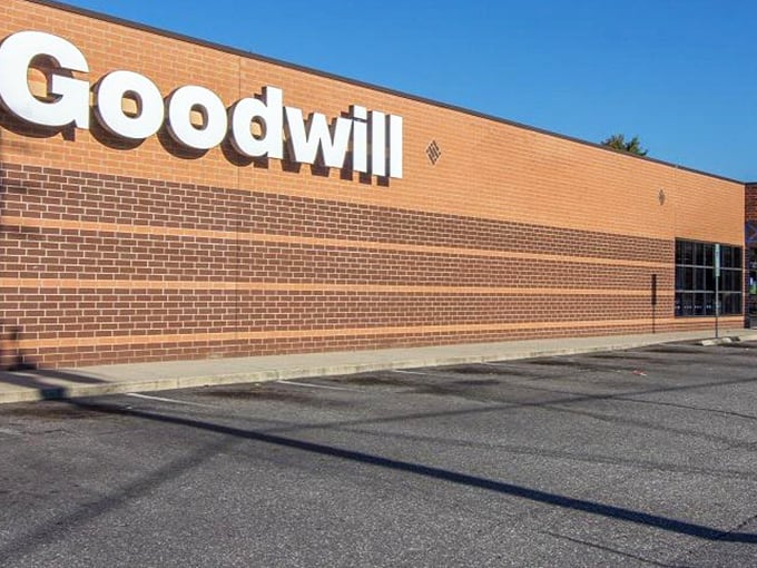 Goodwill's iconic blue sign beckons thrifty shoppers like a lighthouse for bargain hunters. Inside awaits a sea of possibilities!