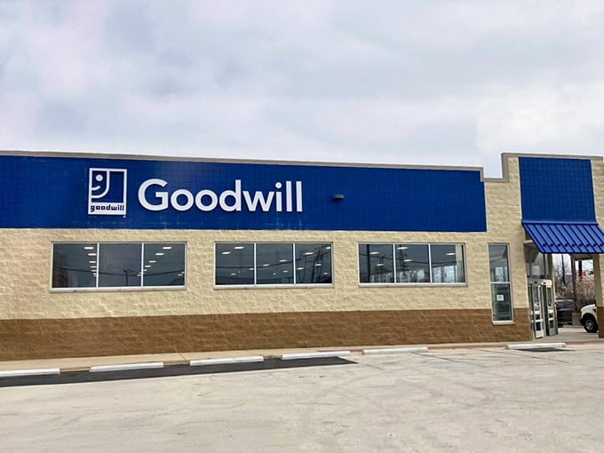 Classic brick-and-blue Goodwill storefront - the retail equivalent of "one person's trash is another's treasure" philosophy in action.
