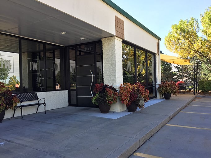Welcoming entrance with seasonal flowers says it all. J. Wilson's doesn't need flashy signs when their steaks do all the talking.