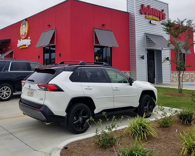 Where pizza pilgrims park their cars and follow their noses. That distinctive red building has witnessed countless "I'm too full but maybe one more slice" moments.