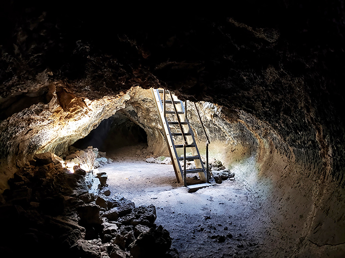 A metal ladder beckons adventurers deeper into the earth. This volcanic playground has been patiently waiting millions of years for your visit.