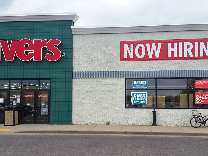 Savers storefront with its "Now Hiring" sign &ndash; join the team that turns yesterday's fashion faux pas into tomorrow's vintage finds.