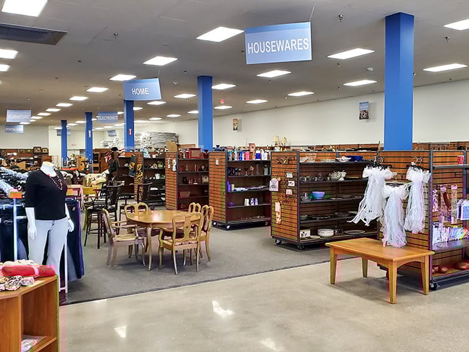 Neatly organized shelves await under bright "HOUSEWARES" signs. Marie Kondo would approve of this thrifter's paradise!