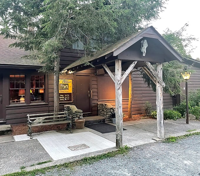 Step into a storybook at twilight &ndash; the Walpack Inn's entrance glows with warmth, beckoning hungry travelers with its woodland magic.