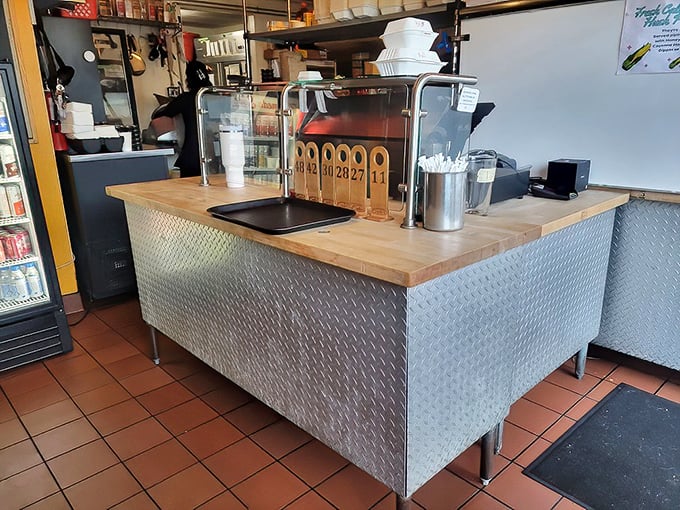 Industrial-chic meets functional at the diamond-plate metal counter, where culinary dreams come true one order number at a time.