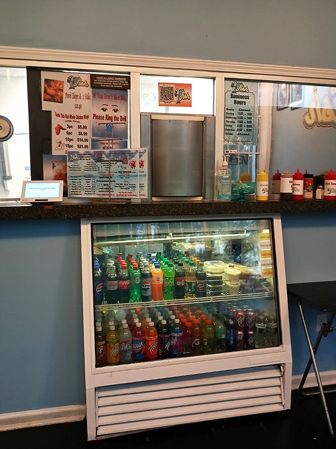 No fancy digital displays here&mdash;just a straightforward menu, colorful soda selection, and condiments standing at attention, ready for duty.