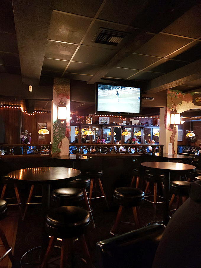 The warm glow of Tiffany-style lamps and dark wood paneling creates the kind of atmosphere where memories are made and steaks are savored.