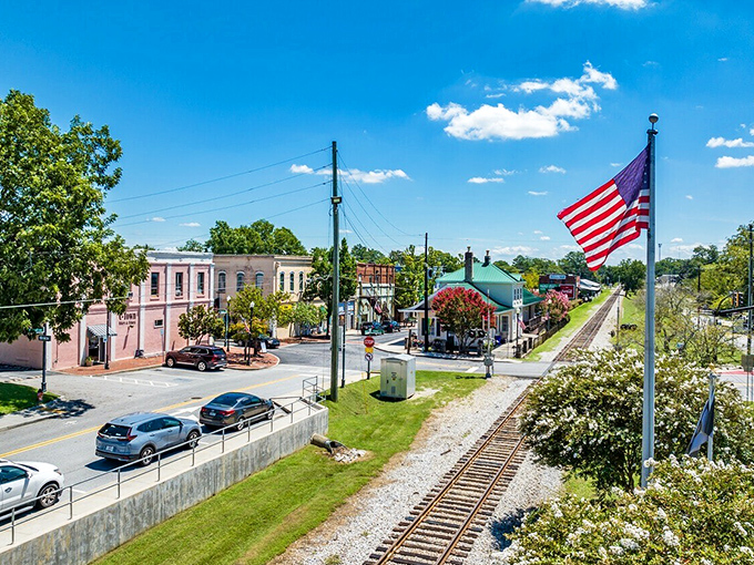 A perfect small-town panorama complete with American flag, railroad tracks, and not a traffic jam in sight. Norman Rockwell would've added this to his portfolio.