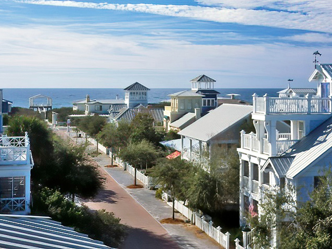 White picket fences and pastel cottages line Seaside's walkable streets, where architectural charm meets Gulf breezes in perfect harmony.