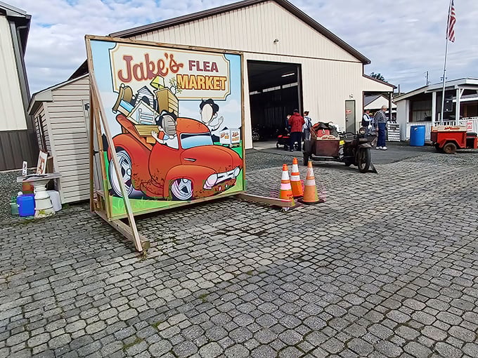 The whimsical entrance sign featuring a cartoon-loaded vintage truck perfectly captures the spirit of Jake's&mdash;a place where nostalgia comes packed in cardboard boxes.