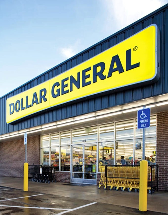 The modern storefront welcomes bargain hunters with its bright yellow signage and neatly arranged shopping carts, ready for retail adventure.