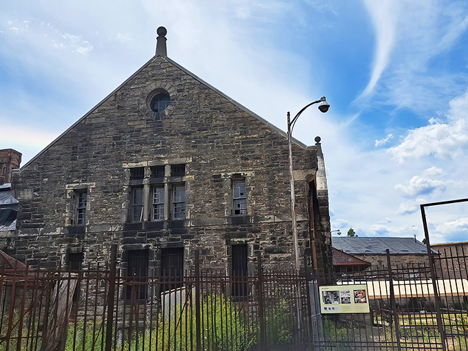 This stone structure with its pointed arch windows and weathered walls whispers of history. Gothic architecture that would make Edgar Allan Poe feel right at home.