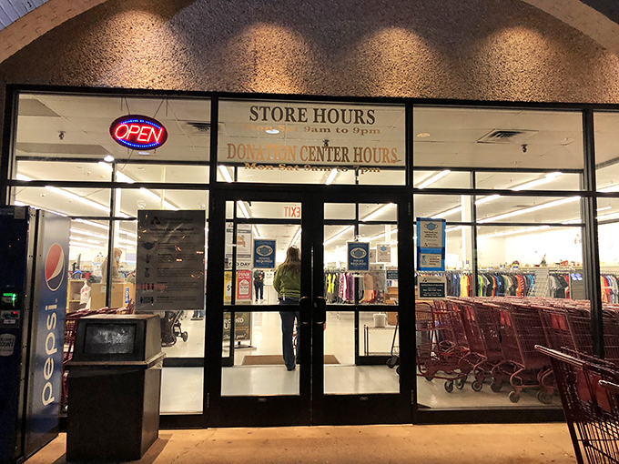 Red shopping carts stand at attention, ready for bargain-hunting adventures. The "OPEN" sign might as well say "Treasure Awaits."