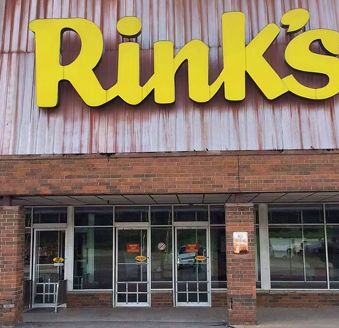 Those iconic yellow letters promise adventure beyond the brick facade. The entrance to Rinky Dink isn't just a doorway&mdash;it's a portal to possibility.
