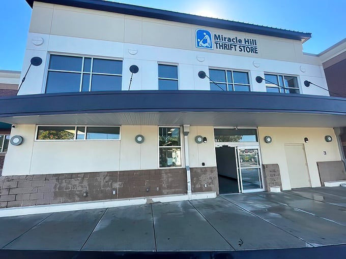 Bright sunlight welcomes shoppers to this modern thrift store entrance, where fashion treasures and home goods await discovery inside.