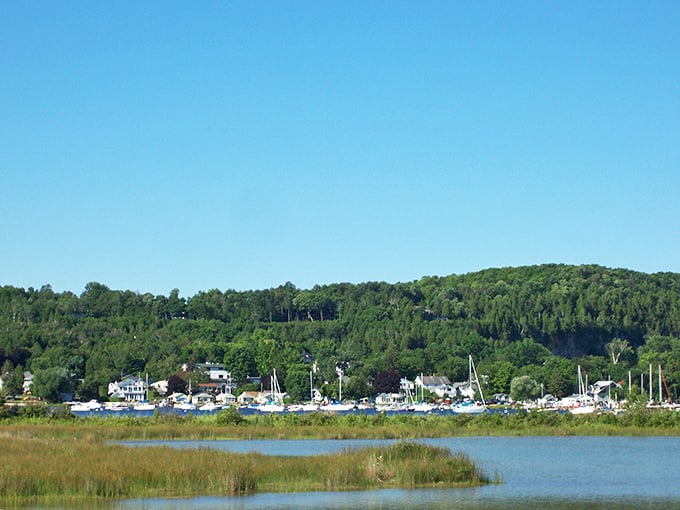 Nature didn't spare any brushstrokes when painting this shoreline. Where sailboats bob like apple dumplings in cinnamon water beneath emerald-draped bluffs.
