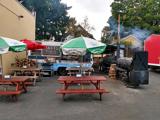 Smoke signals rise from behind the cart, nature's most enticing billboard. Those picnic tables will soon host moments of pure carnivorous bliss.