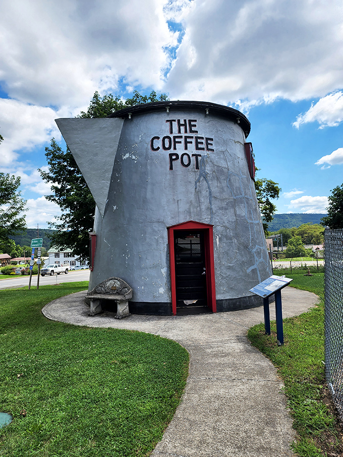 The front entrance beckons visitors with its bright red trim, like a caffeinated lighthouse guiding weary travelers to a moment of roadside wonder.