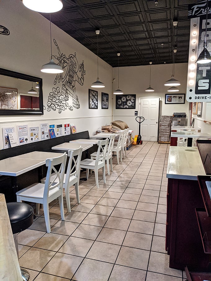 Clean lines, white chairs, and a robot mural create the perfect backdrop for serious donut contemplation.