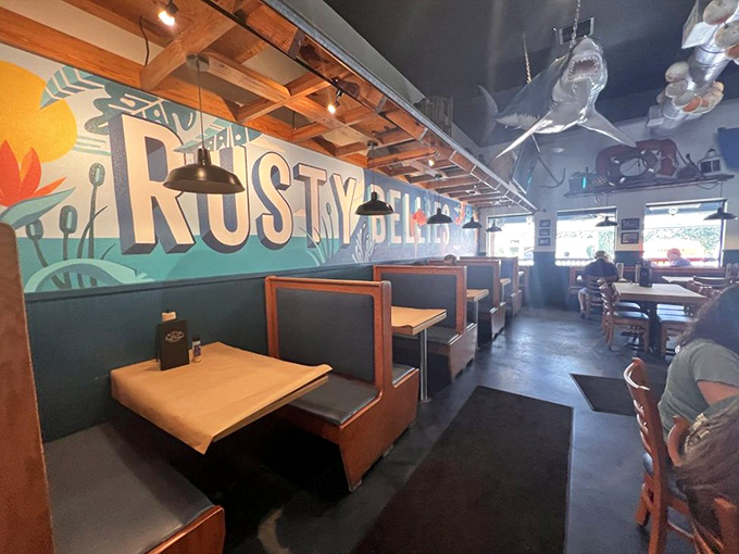 Inside, nautical charm meets casual comfort. That shark hanging from the ceiling? Consider it your dining companion who thankfully already ate.