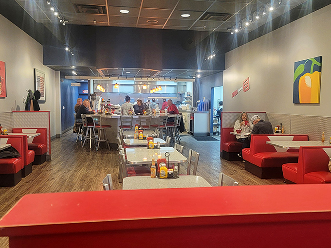 Inside, red booths and counter seating create that perfect diner atmosphere where strangers become friends over coffee refills.
