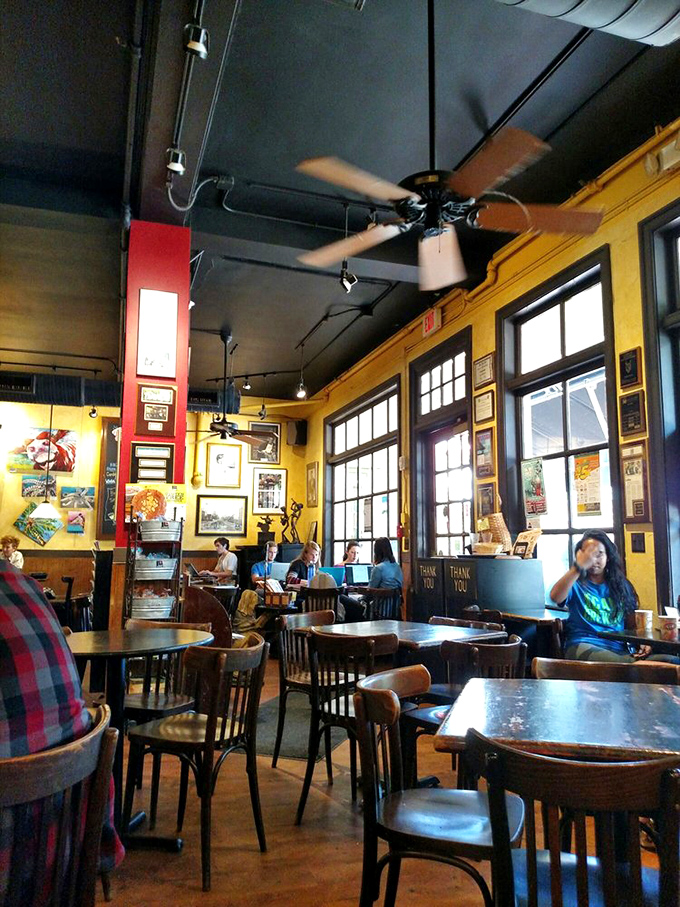 Sunshine-yellow walls and wooden tables create the perfect backdrop for both serious conversations and lighthearted banter in this cozy community hub.