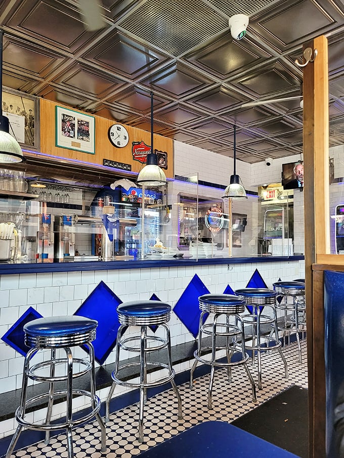 Classic Americana at its finest—chrome stools, blue diamond accents, and a counter where strangers become friends over bottomless cups of coffee.