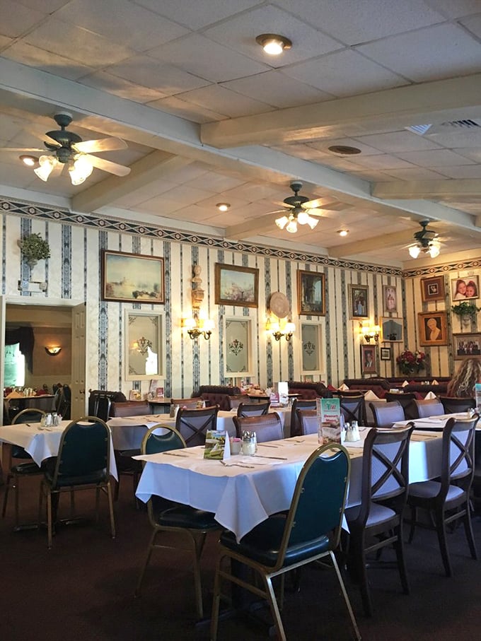 Step into a time capsule of classic Italian-American dining. The striped wallpaper, family photos, and warm lighting create the perfect backdrop for carb-loaded memories.