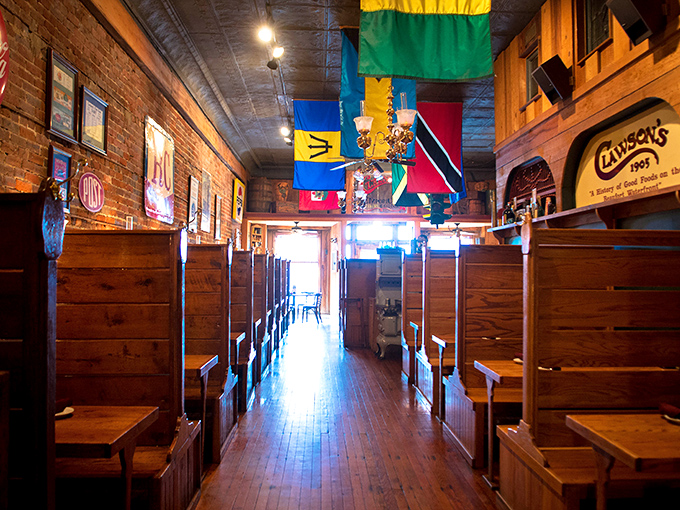 Wooden booths and colorful maritime flags create the perfect nautical atmosphere where conversations flow as freely as the sweet tea.