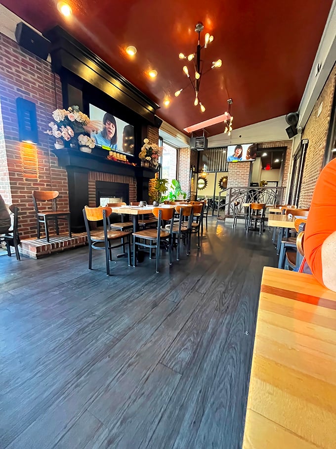 Exposed brick walls meet warm wood tones under a rich copper ceiling&mdash;like dining in a cozy jewelry box designed by someone with actual taste