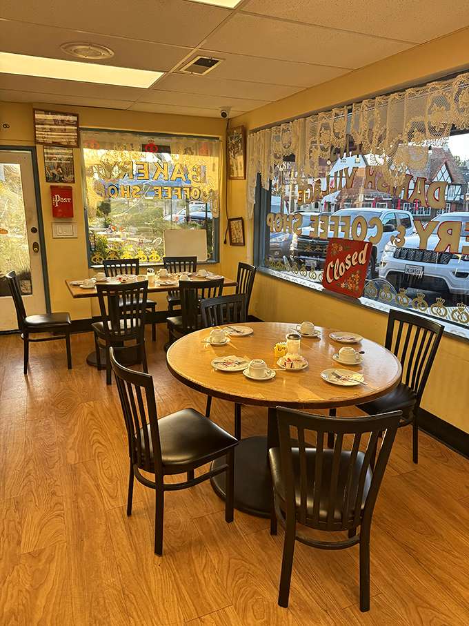 Simple wooden tables and lace curtains create that quintessential Danish hygge feeling. The perfect spot to contemplate life's big question: "Should I order one pastry or five?"