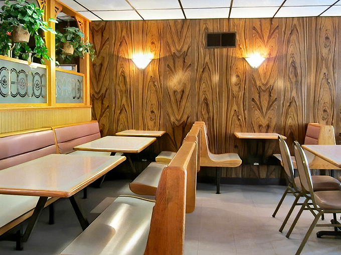 Wood paneling that would make your uncle's 1970s basement jealous creates the perfect backdrop for pizza memories that span generations.