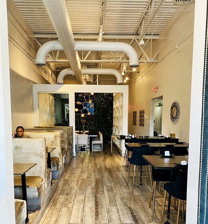 Industrial-chic meets coastal comfort with exposed pipes, wooden floors, and an atmosphere that says "focus on the food, not the frills."