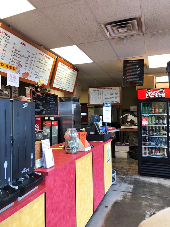 Behind this colorful counter, BBQ dreams come true. The menu board promises smoky delights while your nose confirms you've made the right decision.