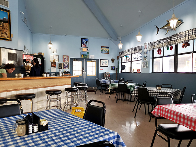 Blue walls, checkered tablecloths, and fishing memorabilia create the perfect backdrop for morning conversations and coffee refills.