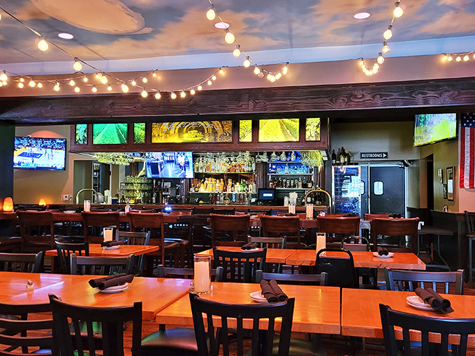 String lights and sky-painted ceilings create the perfect mood for meat meditation. The bar beckons with liquid promises while wooden beams add rustic charm to every carnivorous celebration.