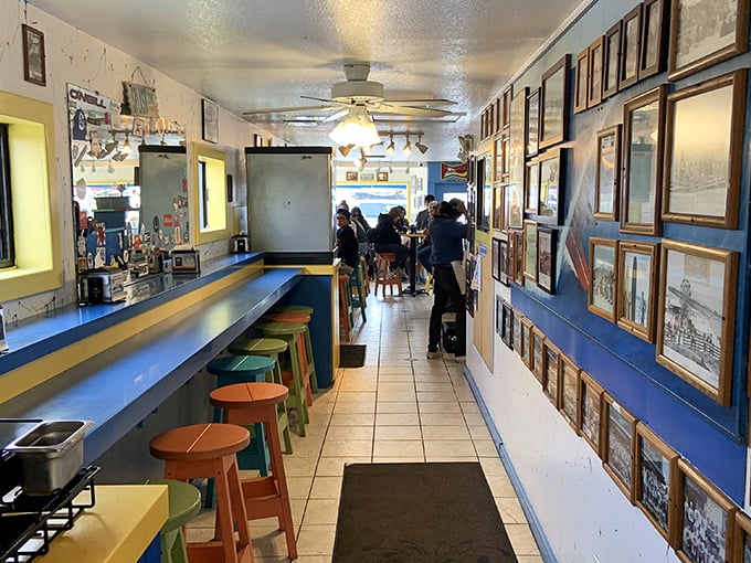 Inside, the narrow hallway feels like a gallery of local memories, with colorful stools inviting you to pull up and stay awhile.