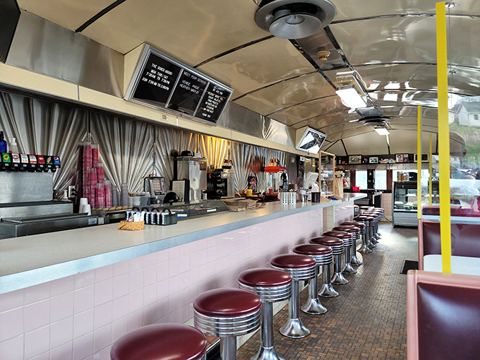 Classic red vinyl stools line the counter where breakfast dreams come true, offering front-row seats to the short-order cooking show that never gets old.