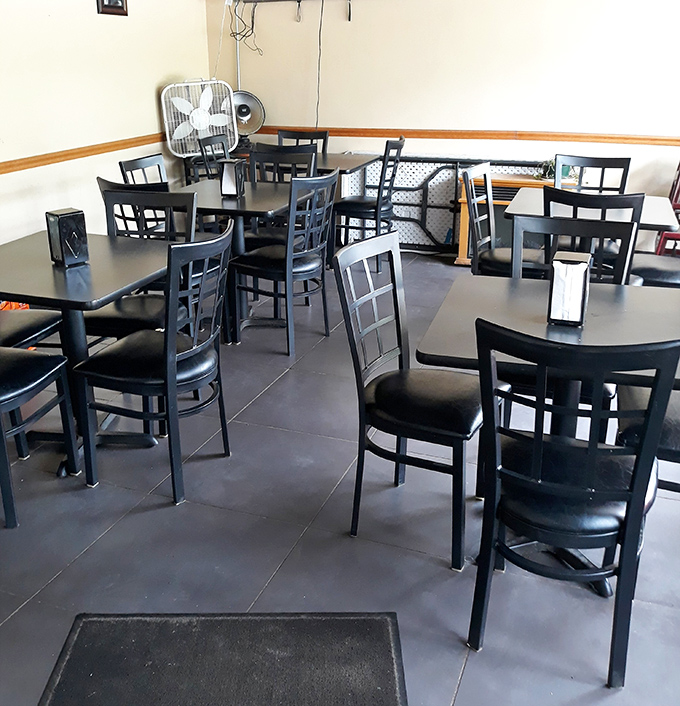 No-frills dining at its finest. These black tables and chairs have witnessed decades of family celebrations, first dates, and the simple joy of great pizza.