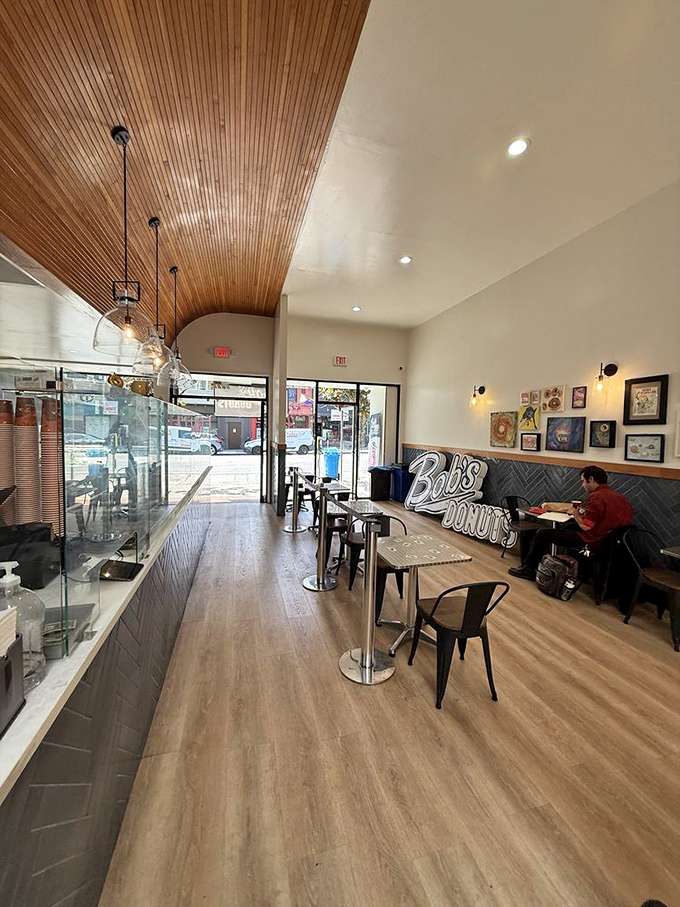 Wood-paneled ceilings and simple seating create the perfect stage for the real stars: those magnificent donuts waiting behind glass.