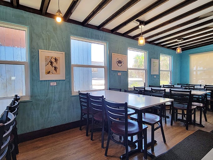 Simple wooden tables, aqua walls, and natural light create that perfect "I've discovered something special" feeling that makes vacation memories last.