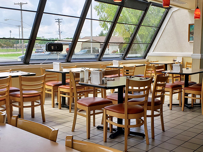 Sunlight floods through those distinctive angled windows, creating the perfect backdrop for comfort food conversations and coffee refills.